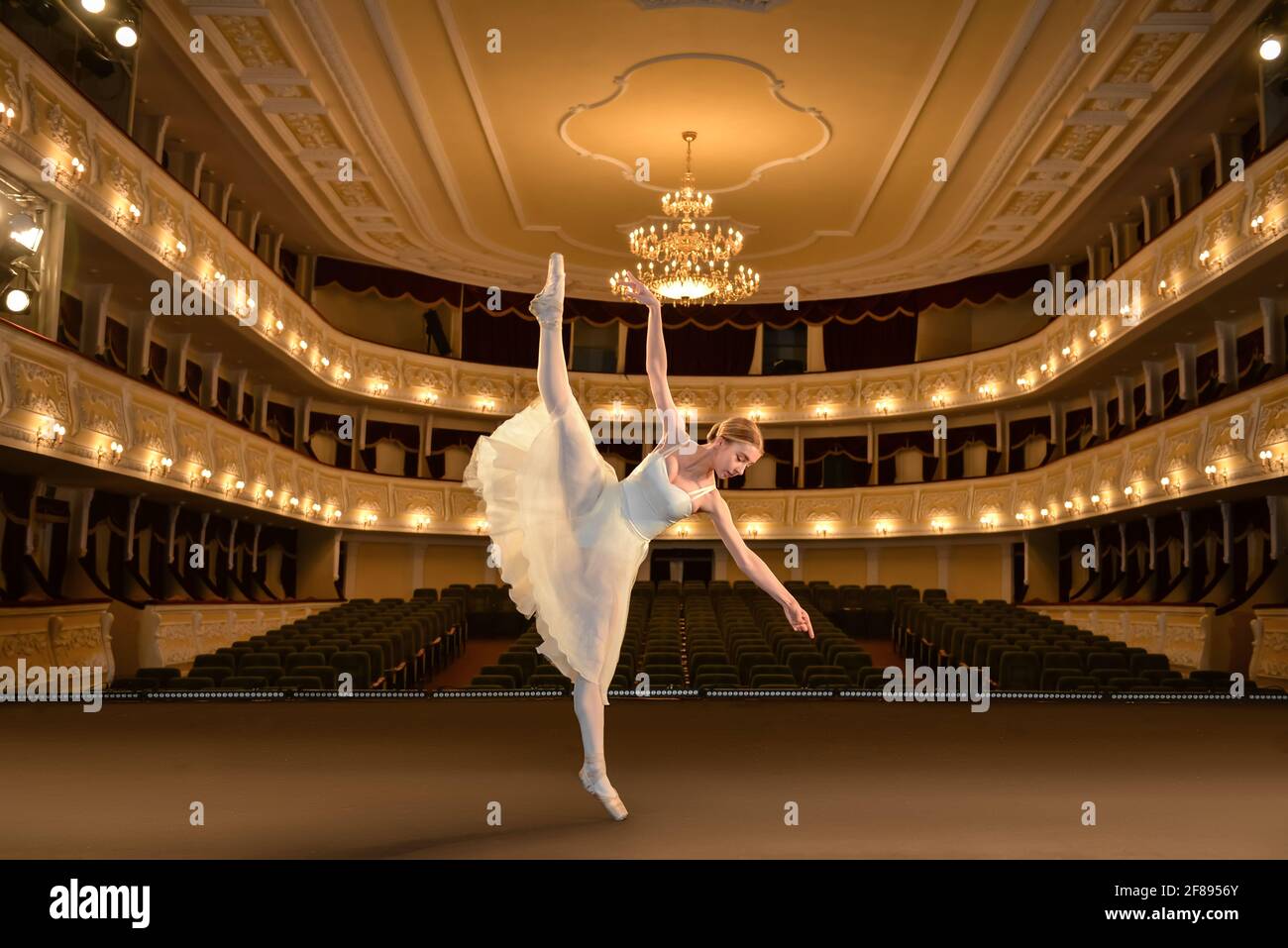 Beautiful young ballerina dancing in theatre Stock Photo - Alamy
