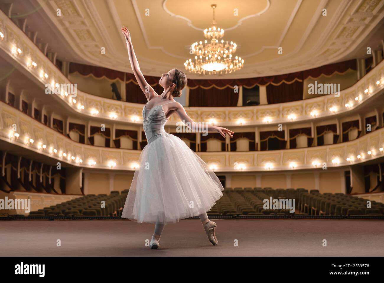 Beautiful young ballerina dancing in theatre Stock Photo - Alamy