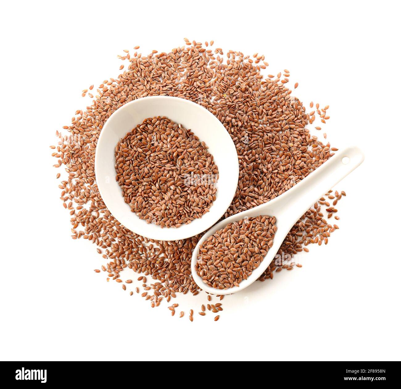 Bowl and spoon with flax seeds on white background Stock Photo - Alamy