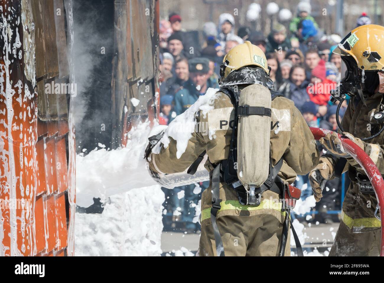 Firefighters extinguishing fire from fire hose, using fire-fighting ...