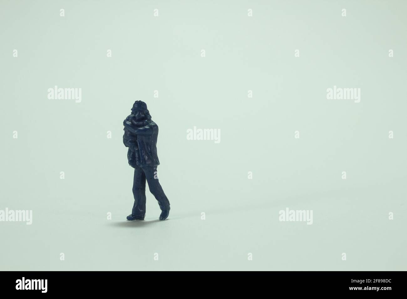 Minifigure of a parent hugging and carrying his child /miniature people ...