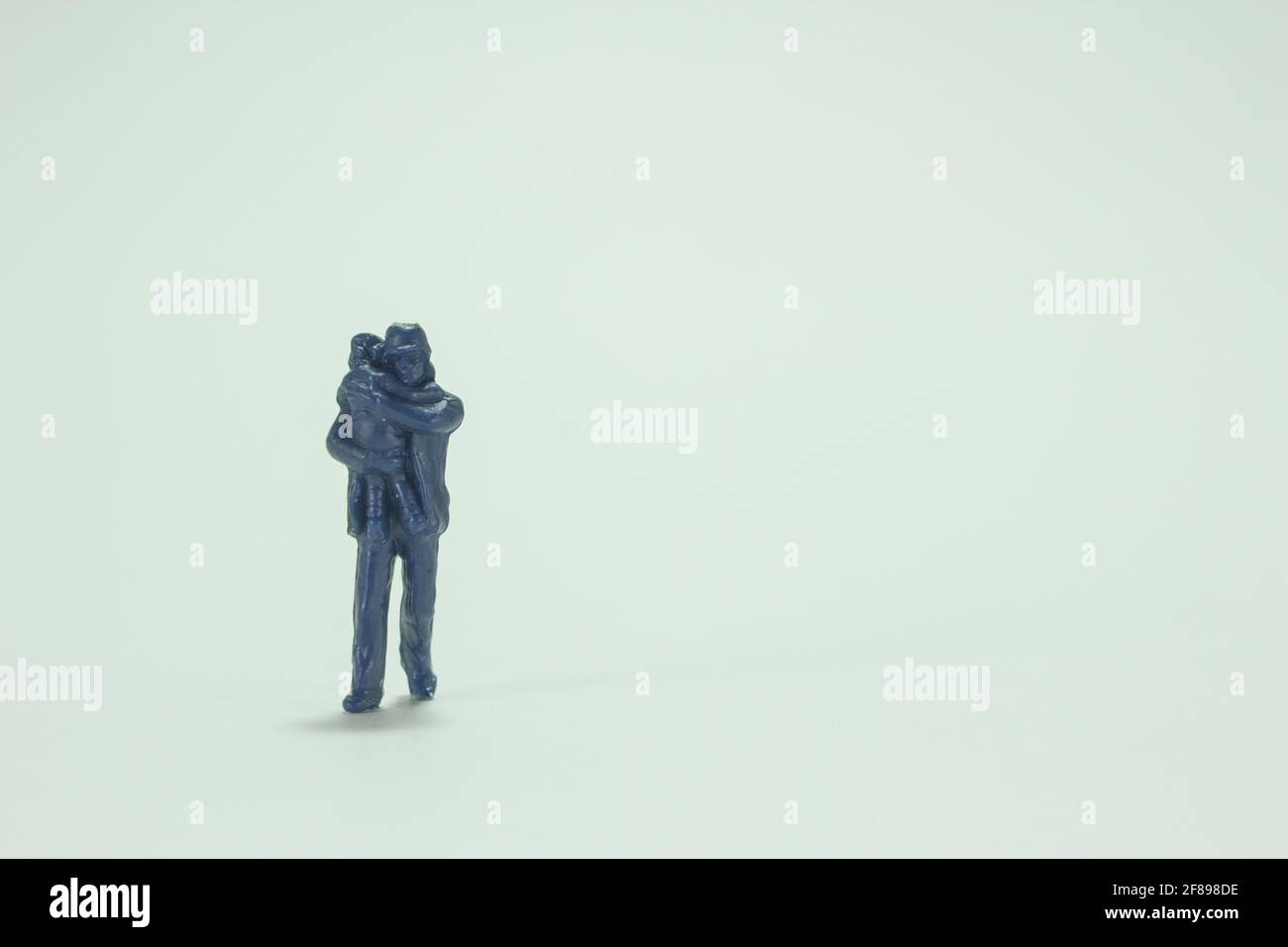 Minifigure of a parent hugging and carrying his child /miniature people ...