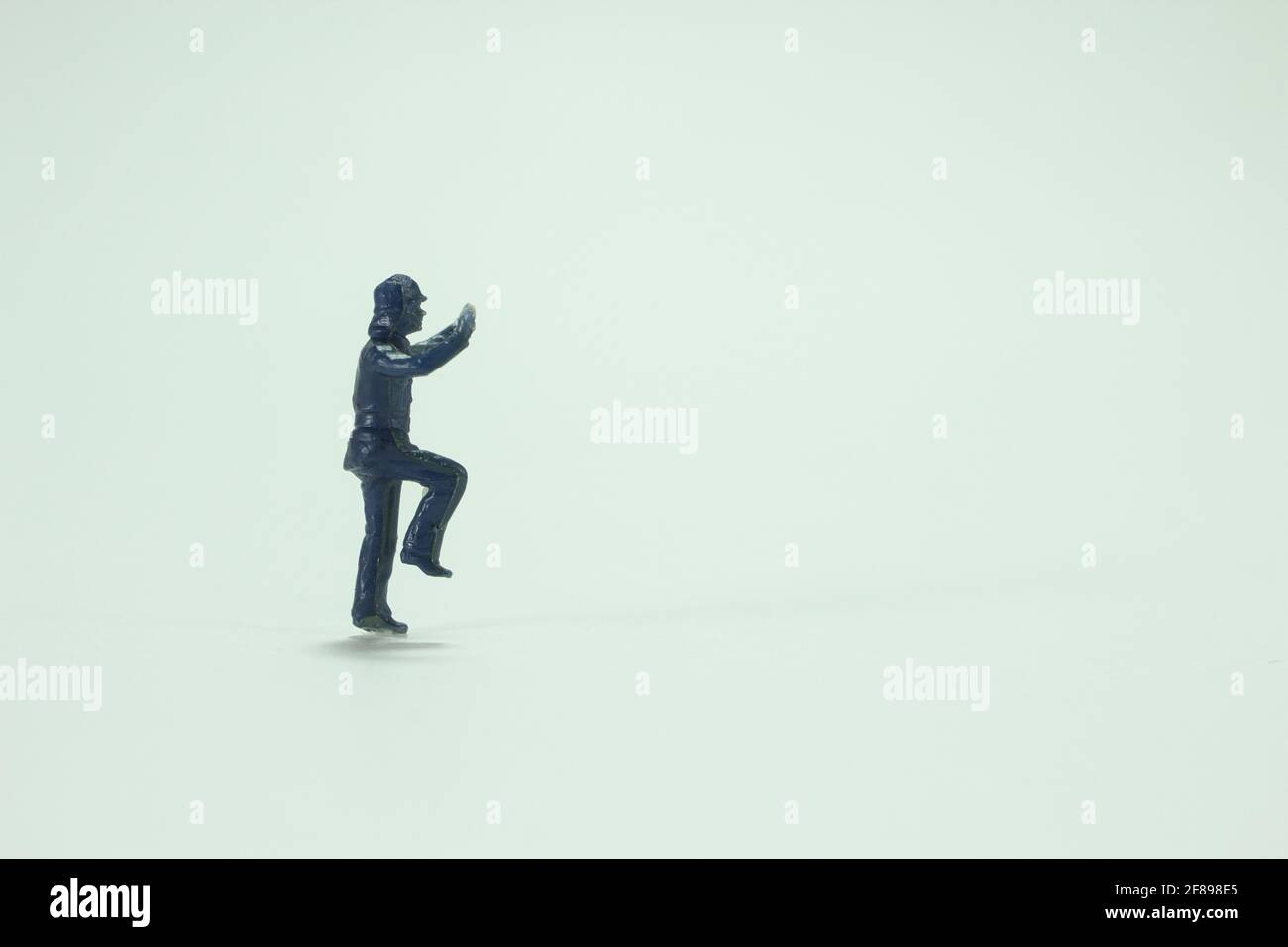 Minifigure of a person standing on one leg with raised arms /miniature ...