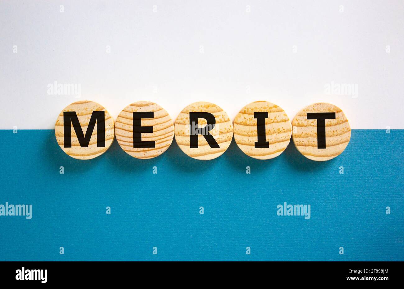 Merit symbol. Wooden circles with the word 'merit'. Beautiful white and ... Merit symbol. Wooden circles with the word 'merit'. Beautiful white and ...
