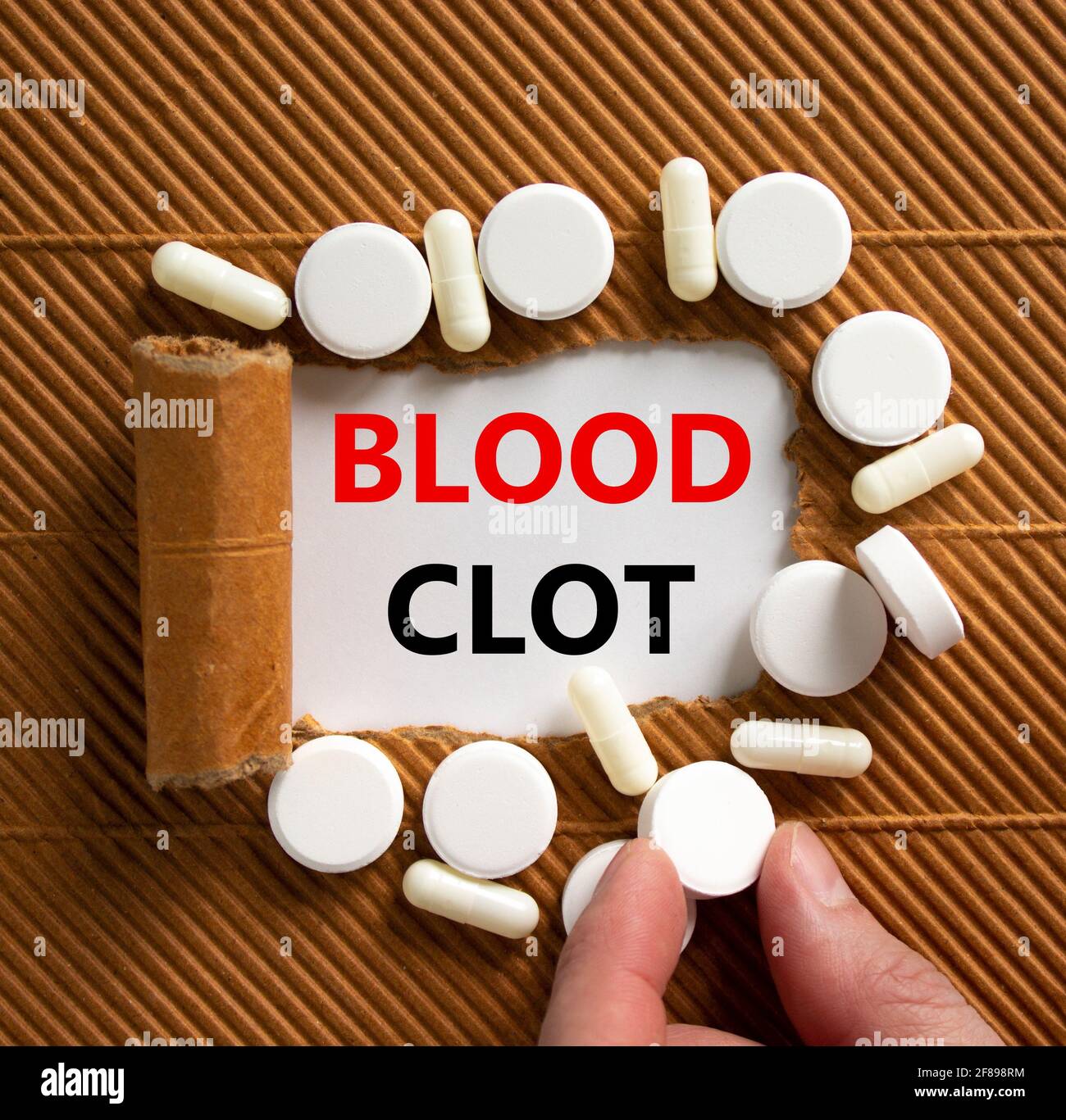 Medical and blood clot symbol. Words 'Blood clot' appearing behind torn ...