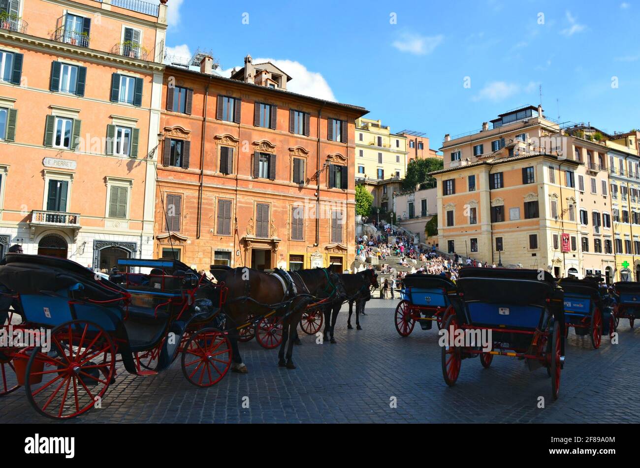 Horse drawn carriages in Piazza di Spagna with view of the Spanish ...