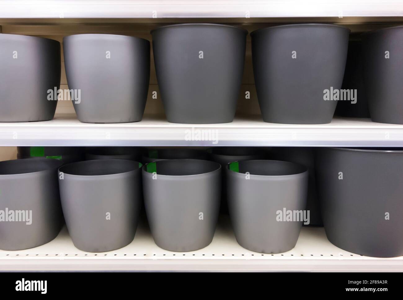 New gray flower pots on the shelves Stock Photo - Alamy