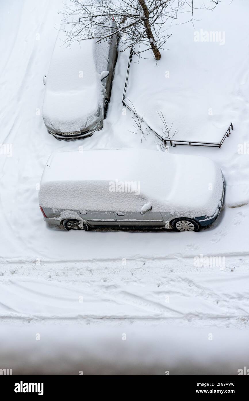 Overhead shot of cars fully covered with fresh thick February snow St ...
