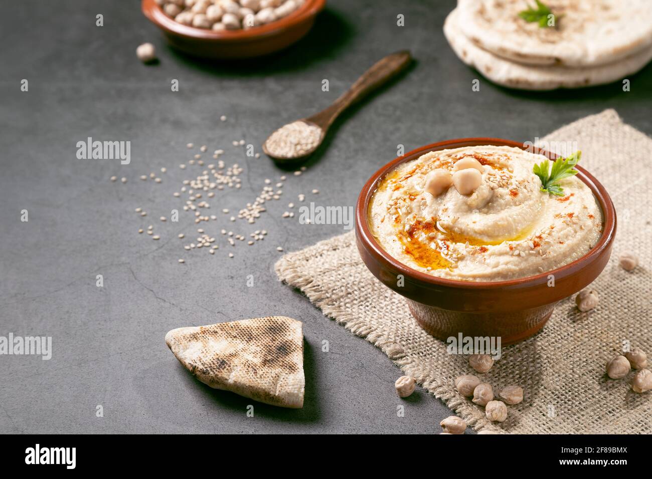 Bowl of homemade hummus on dark background with copyspace Stock Photo ...