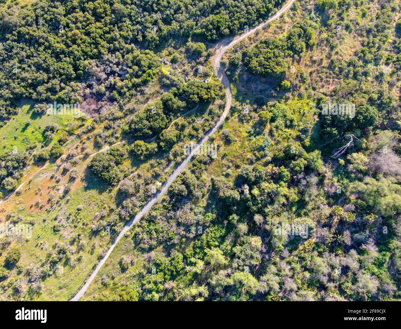 Aerial view of hiking sandy trails in dry green mountain, perfect for ...
