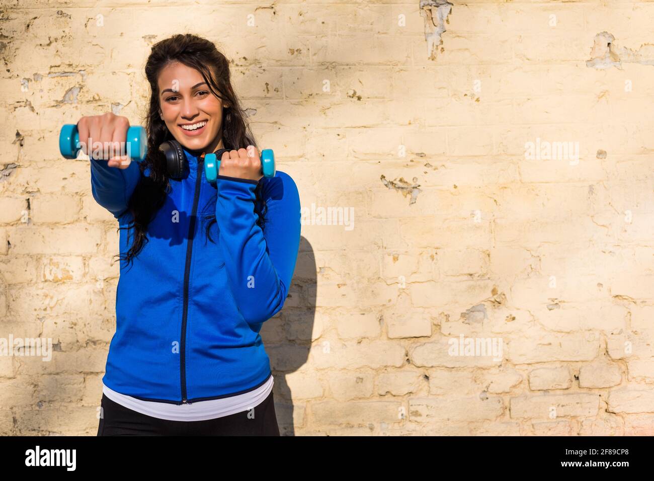 Beautiful woman exercising outdoor with weights outdoor Stock Photo - Alamy