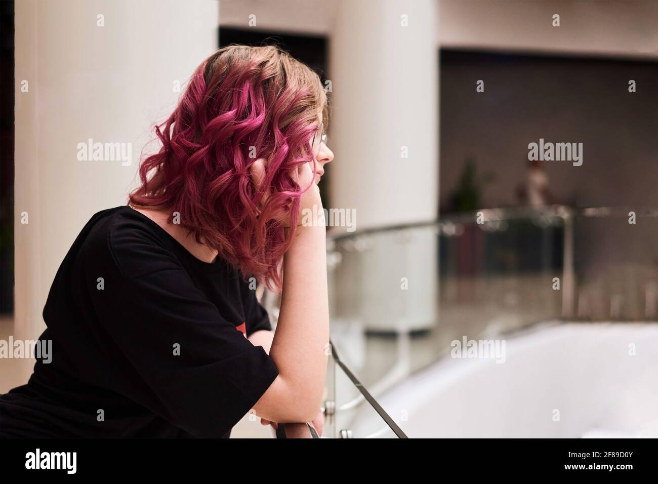 bored girl with pink hair in shopping mall look into distance Stock ...