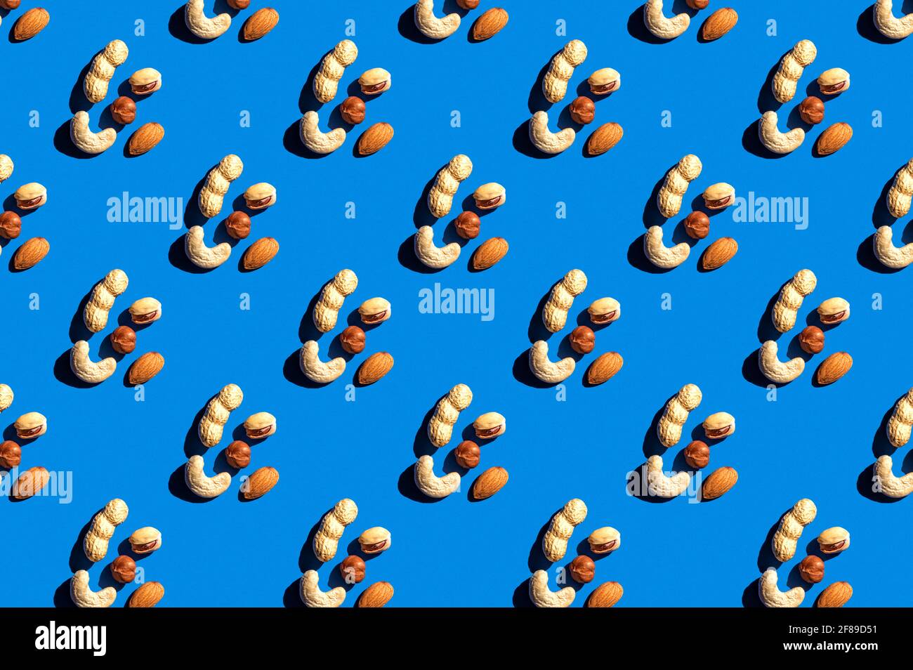 Pattern from mix nuts on blue background. Pattern from different nuts ...