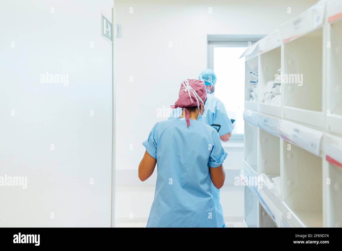 Doctors using cell phones in the hospital corridor. Medical concept ...