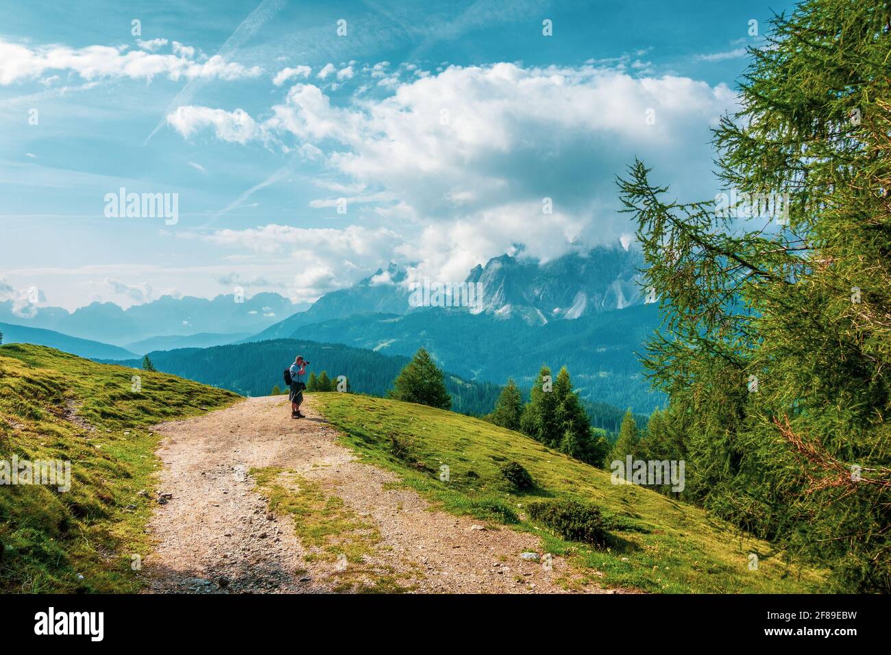 A tourist with a photo camera in the Dolomites, Italy Stock Photo - Alamy