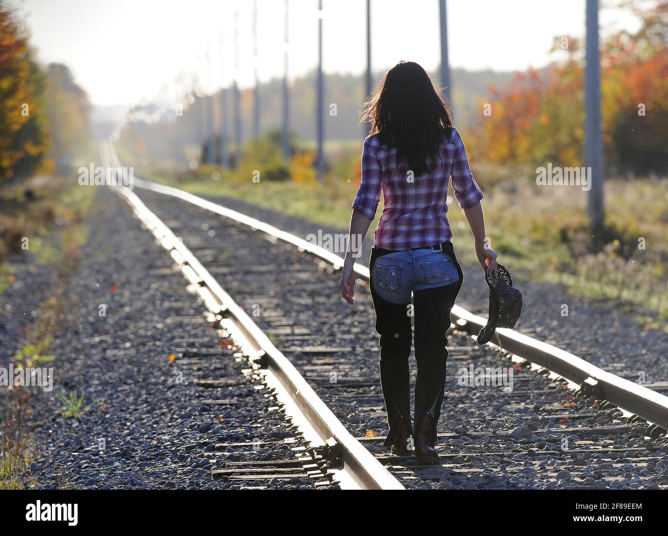 woman walks alone on the railway Stock Photo - Alamy