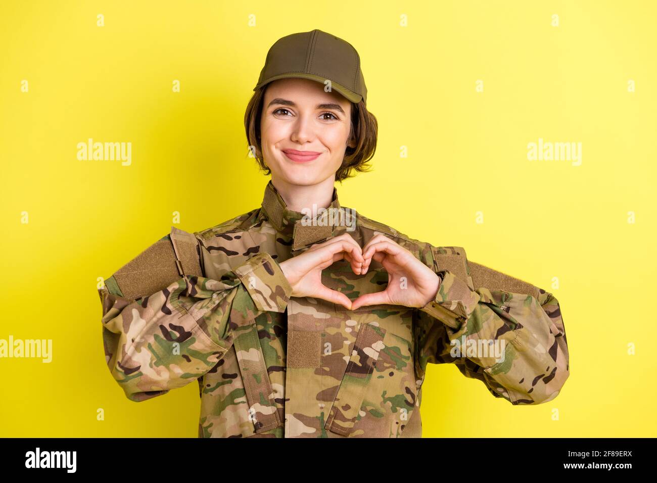 Portrait of charming satisfied girl hands fingers show make heart ...