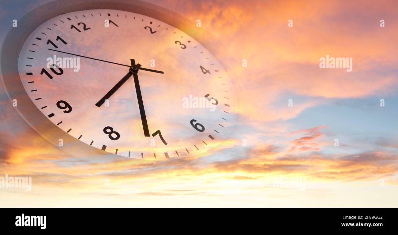Clock face in bright sky. Time passing Stock Photo - Alamy