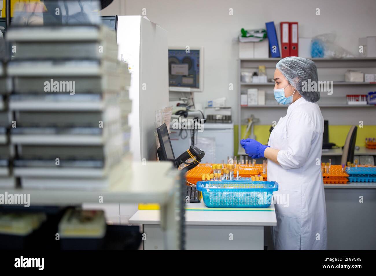 Lab technician in uniform works with samples of tests Stock Photo - Alamy