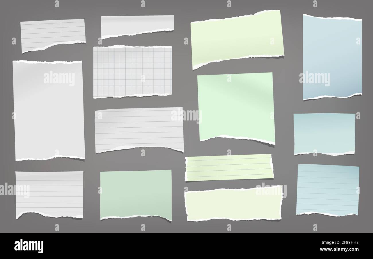 Torn of white, green and blue note, notebook paper pieces are on dark ...