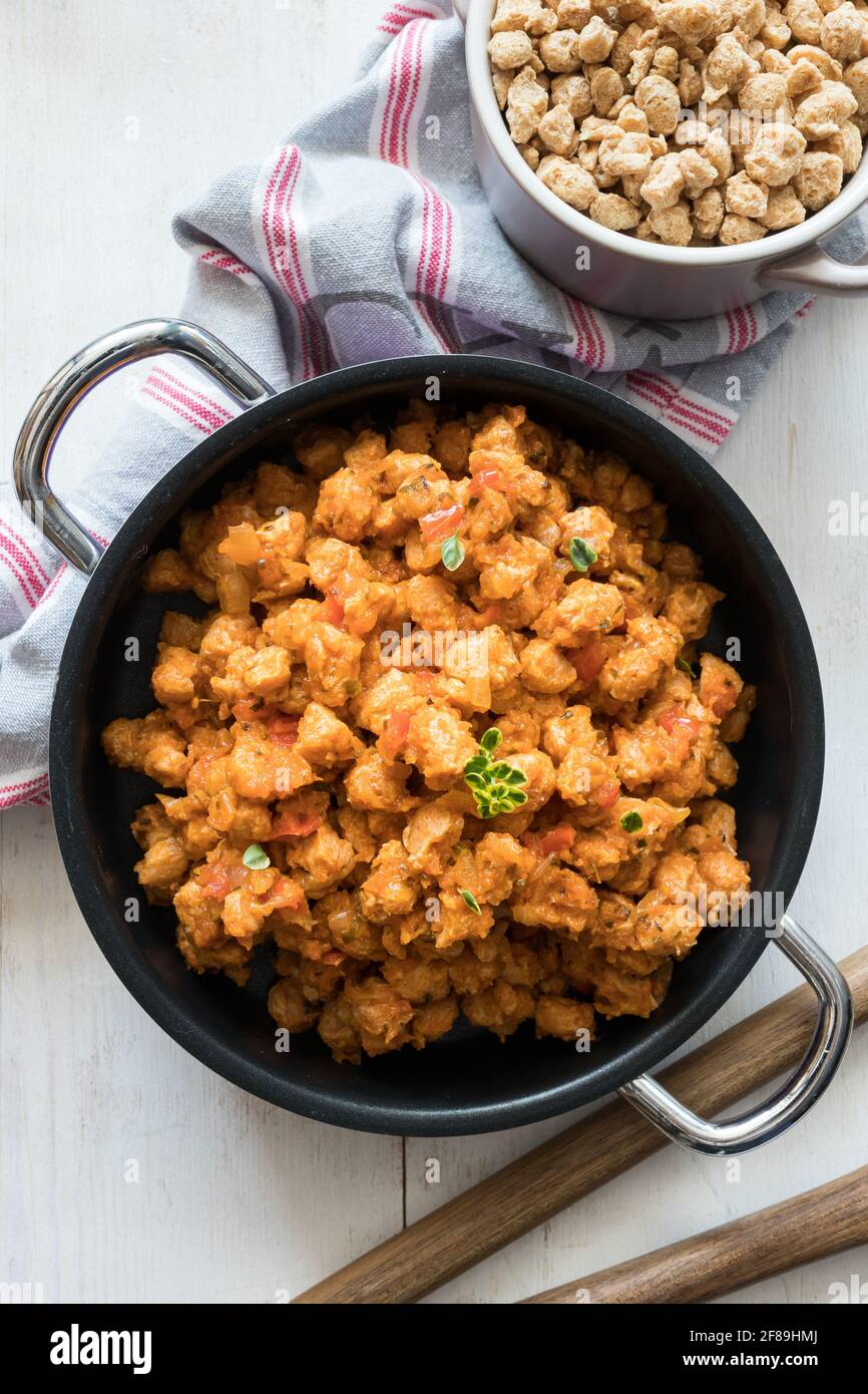 A black casserole full of healthy bolognese soya meat Stock Photo - Alamy