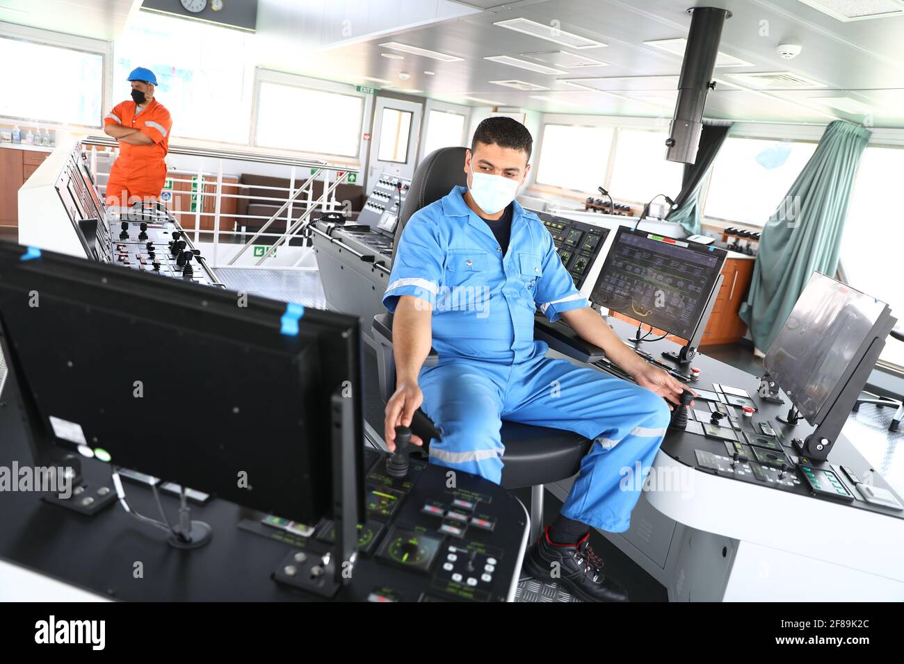 Ismailia, Egypt. 12th Apr, 2021. A crew member sits in the control ...