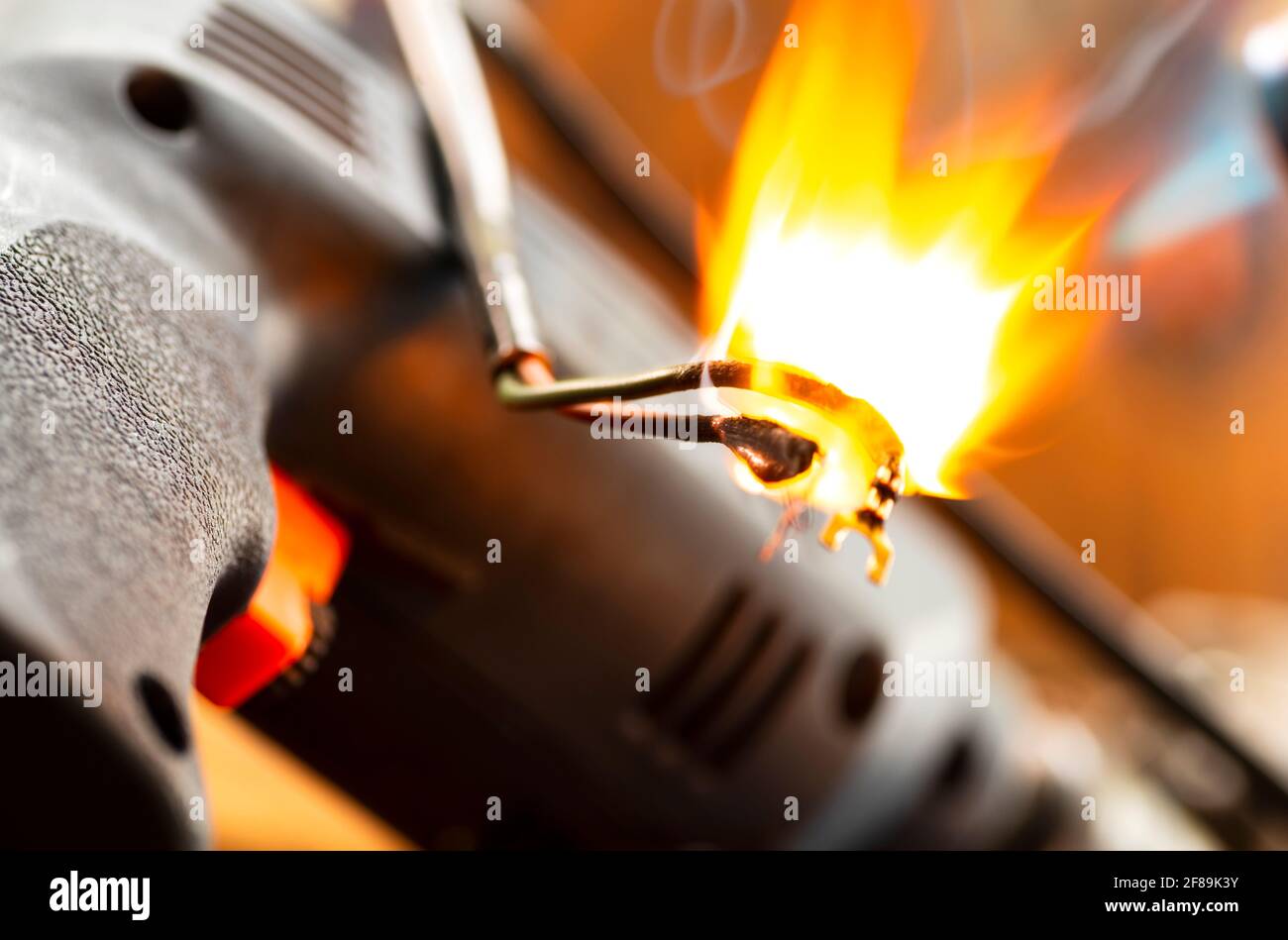 Burning wires on parts of an electrical appliance in a repair shop ...