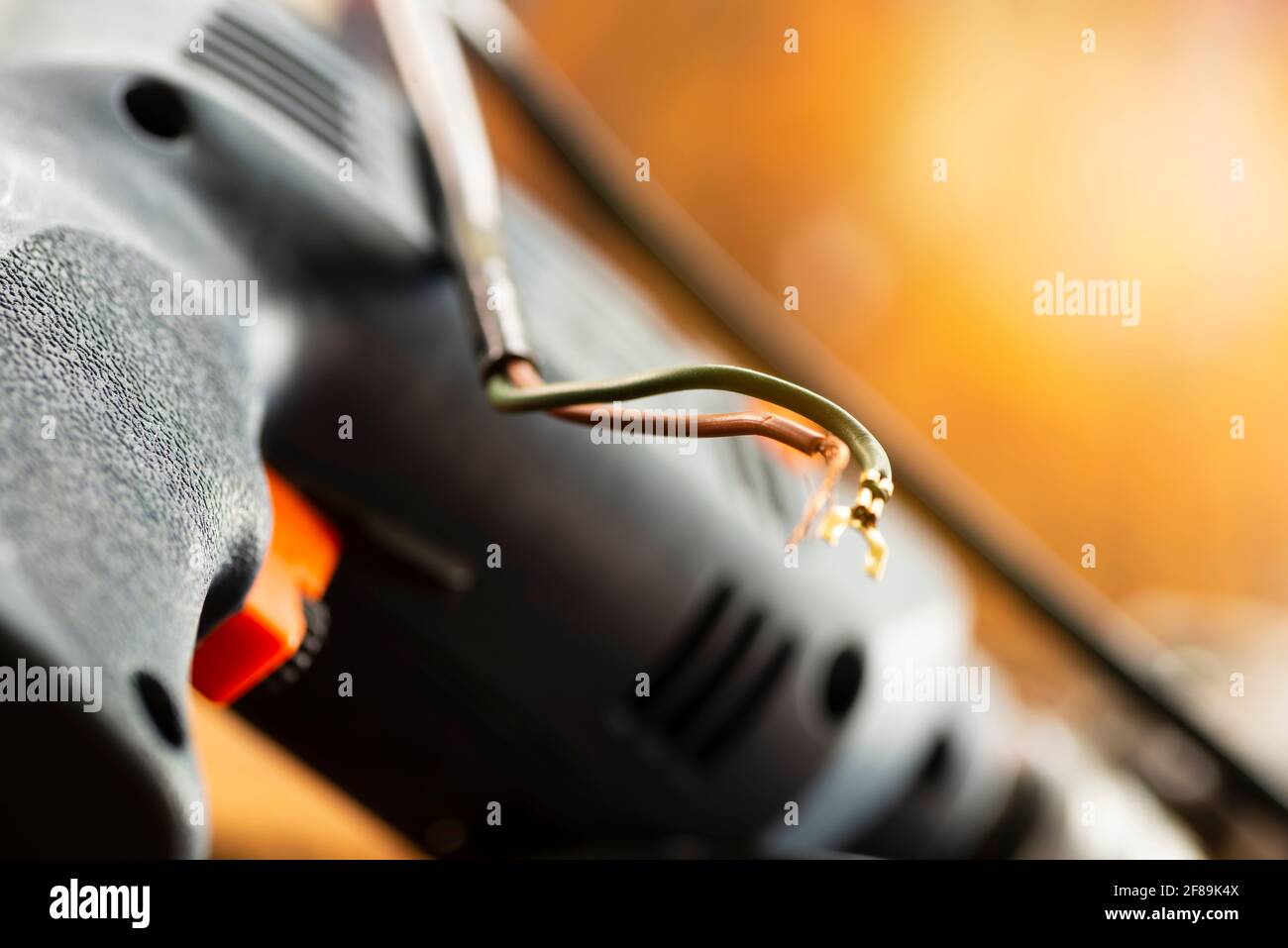 Broken wires from an electrical appliance in a repair shop. Power tool ...