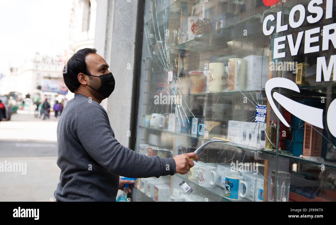 A gift shop worker cleans the shop during the reopening. Shops ...