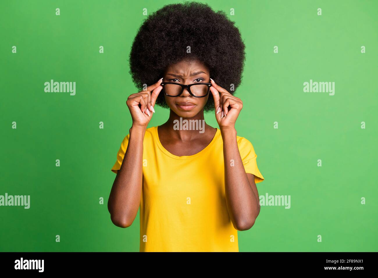Photo of young unhappy upset mad afro girl in glasses staring angrily ...