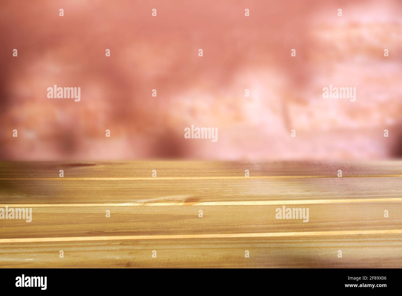 Rustic light brown wooden empty table top against red blurry brick wall ...