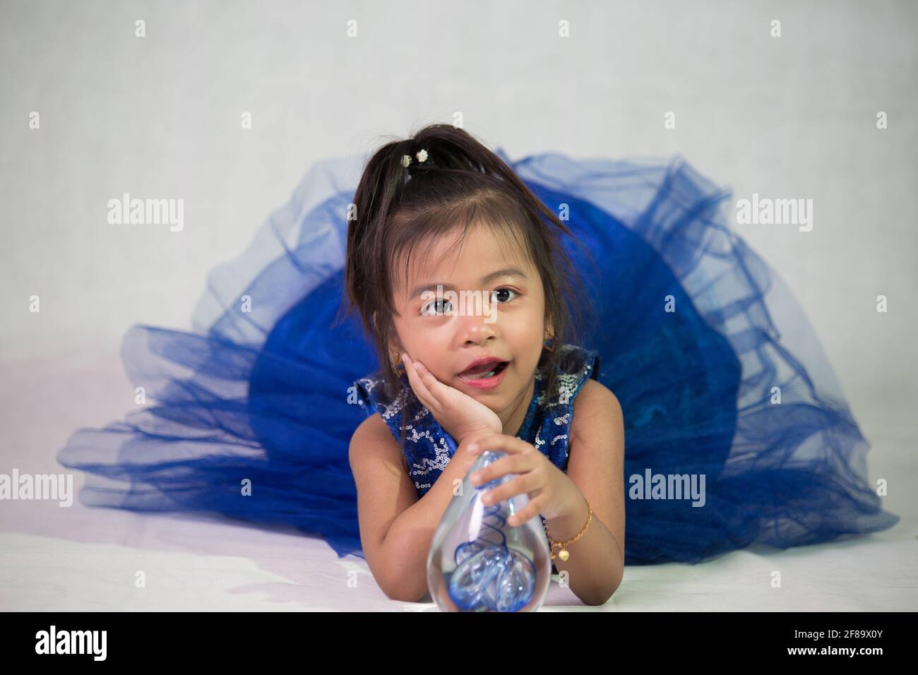 Beautiful shot of an adorable Southeast Asian baby girl wearing a blue ...