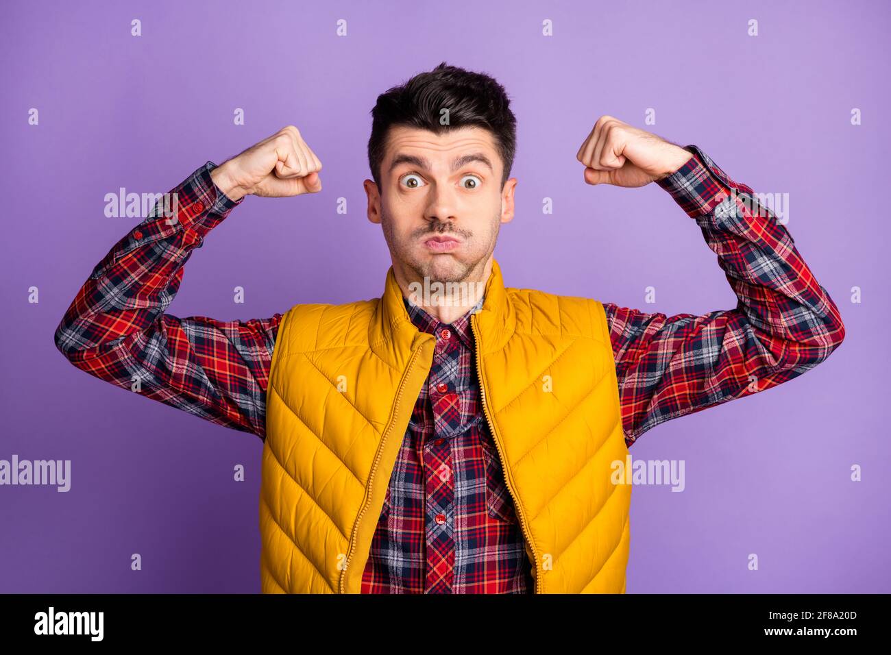 Photo of funny childish young man wear yellow sleeveless jacket bloated ...