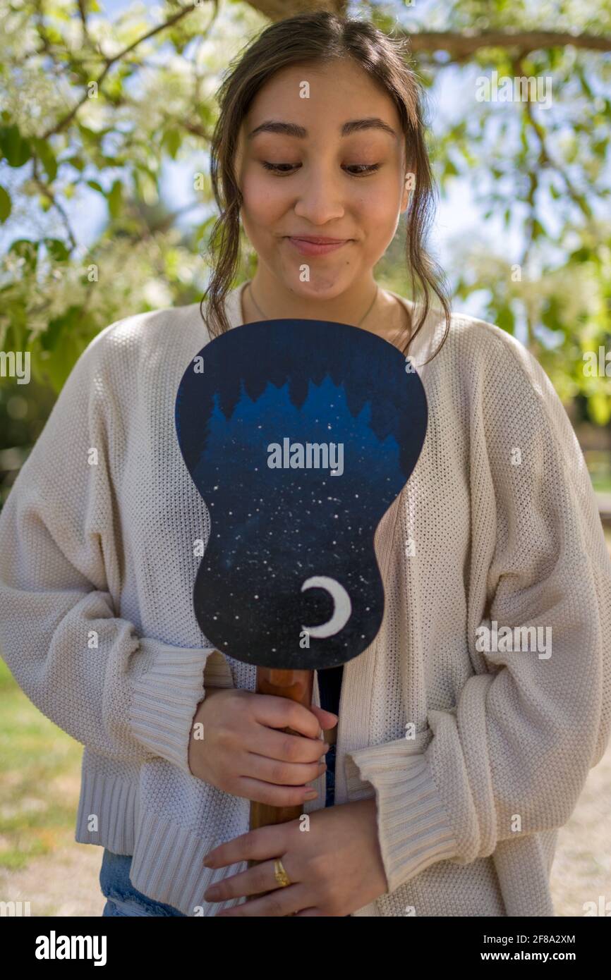Petite Asian teenager standing with ukulele Stock Photo - Alamy