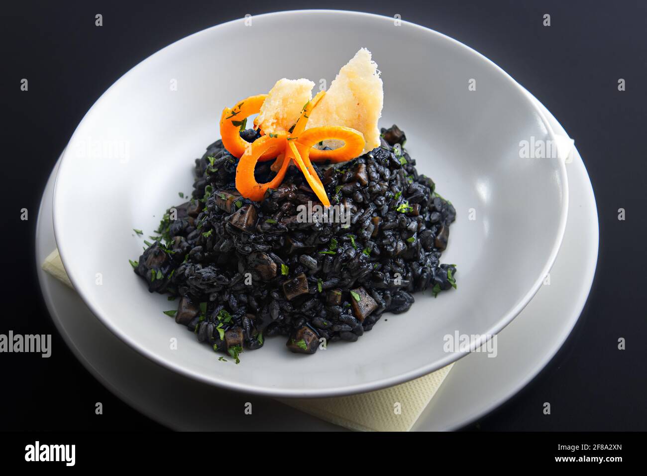 black risotto with scampi and seafood Stock Photo - Alamy