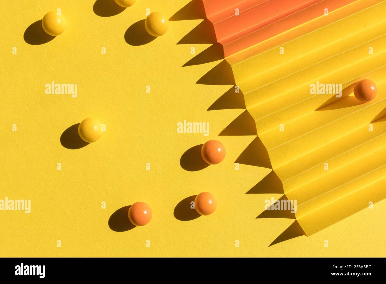 Abstract orange and yellow colored paper texture. Folded paper with ...