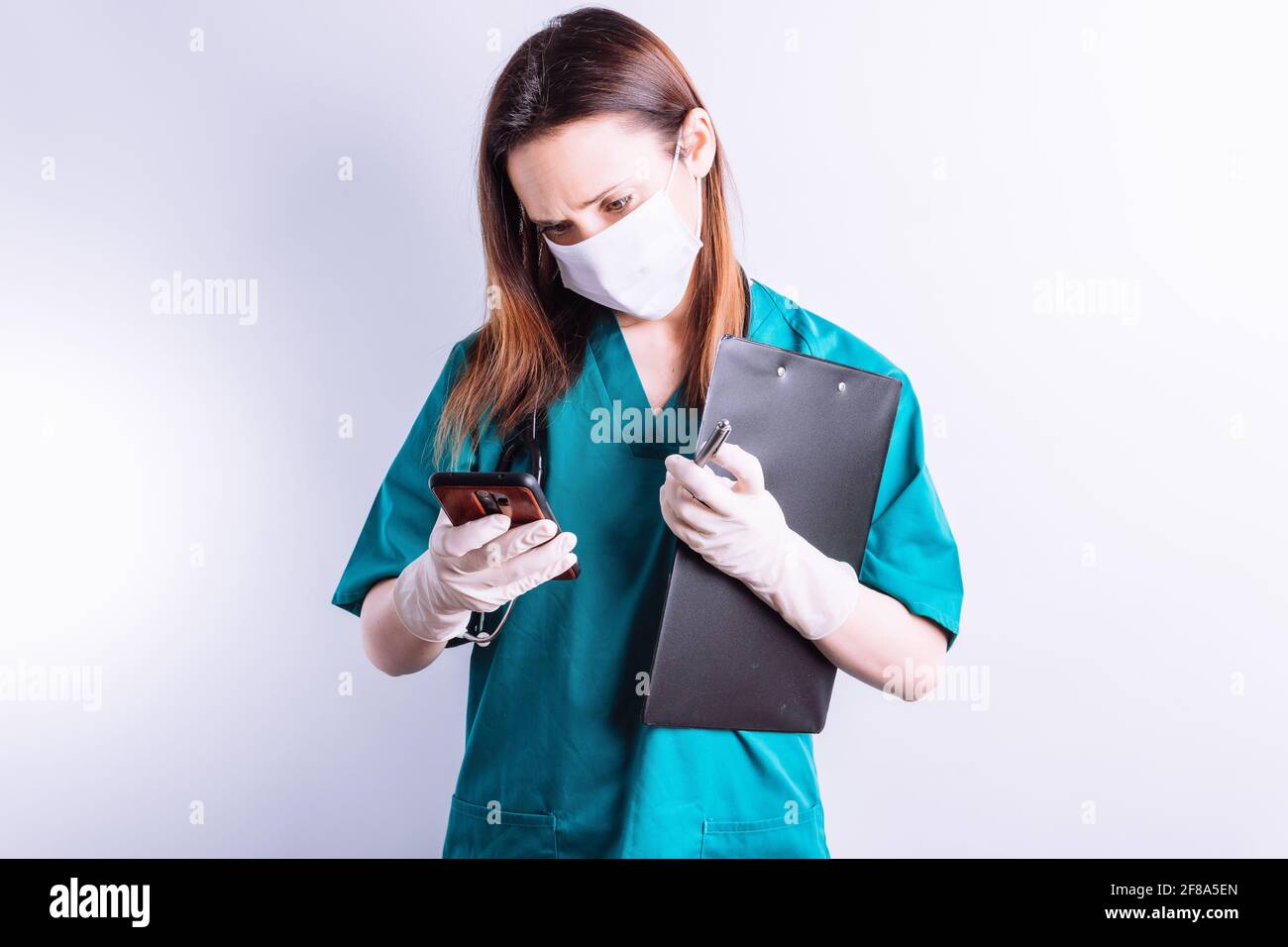 Medical doctor sending message to patient with mobile phone holding a ...