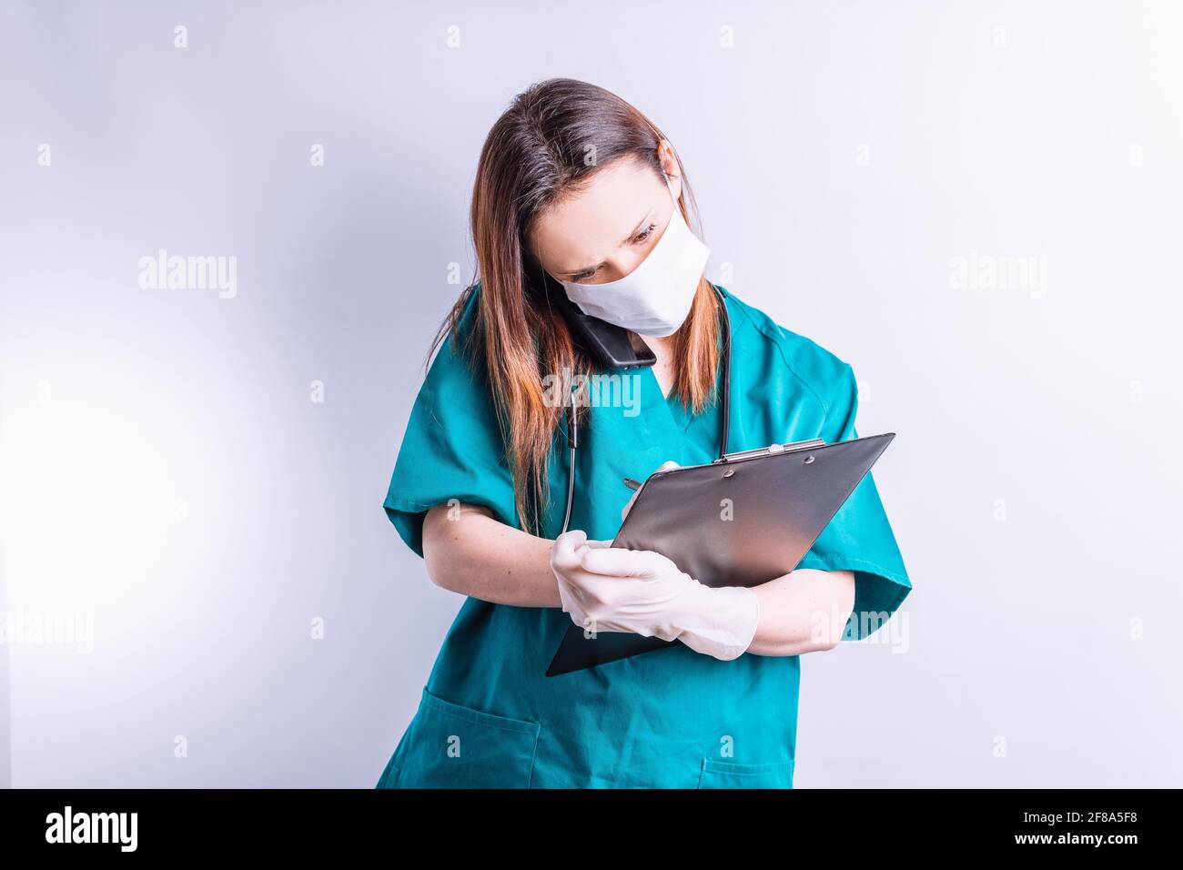 doctor Attending patient by phone writing a report point concept ...