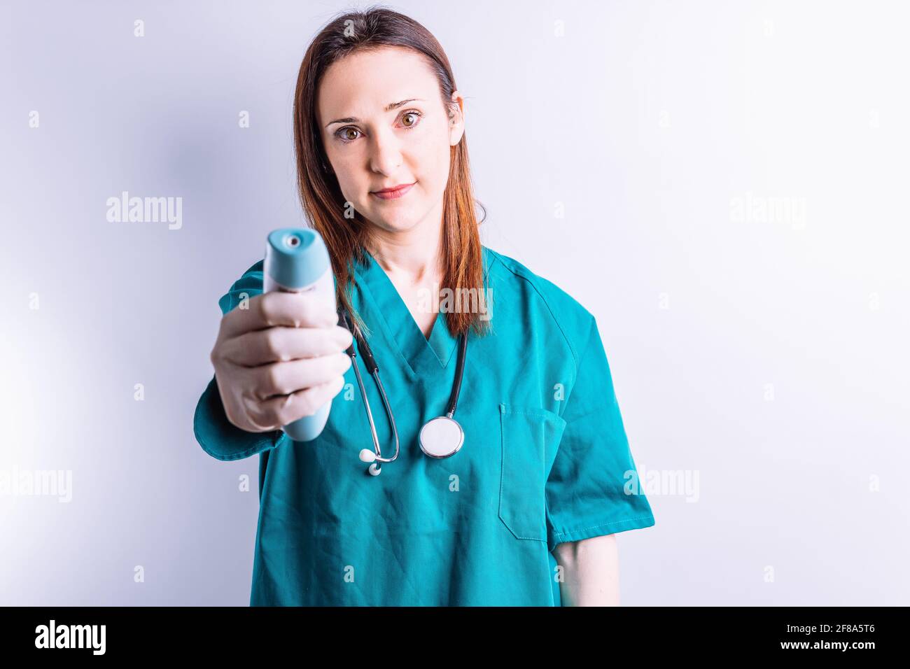 Doctor with stethoscope and gloves pointing to the front with a laser ...