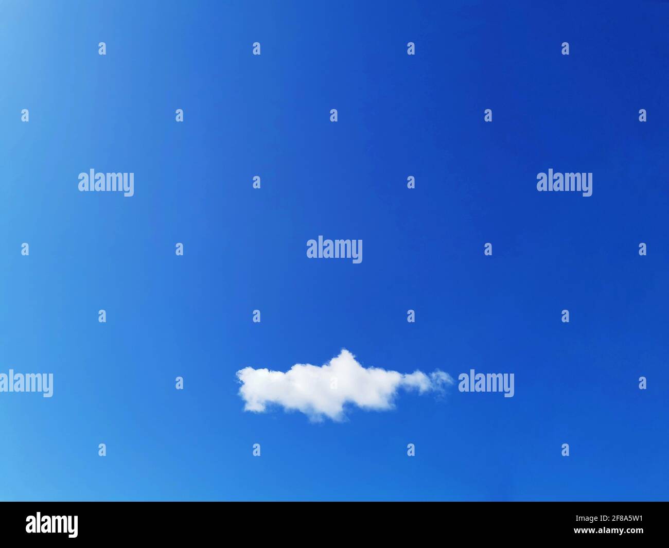 Small white cloud in the sky Stock Photo - Alamy