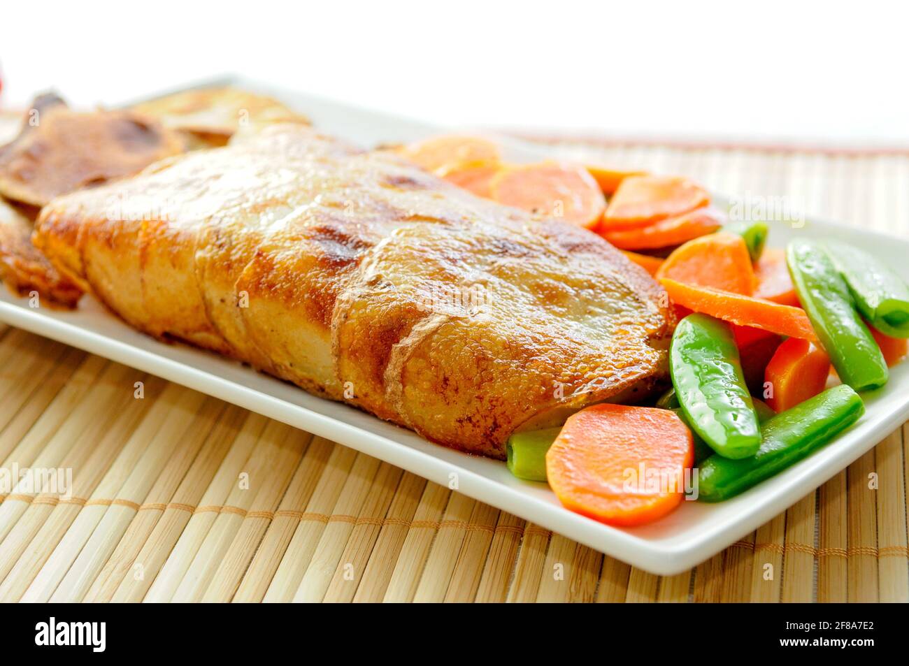 Potato wrapped halibut fish fillets Stock Photo - Alamy