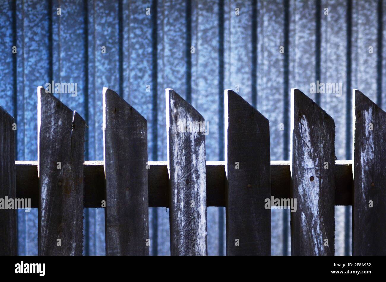wooden lath fence with a metal wall in background Stock Photo - Alamy