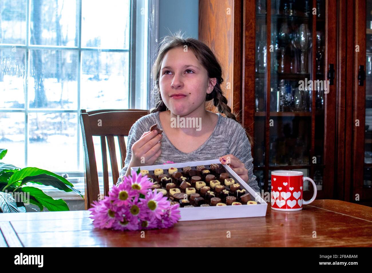 young girl makes a bad face as she tastes a disagreeable flavor of ...