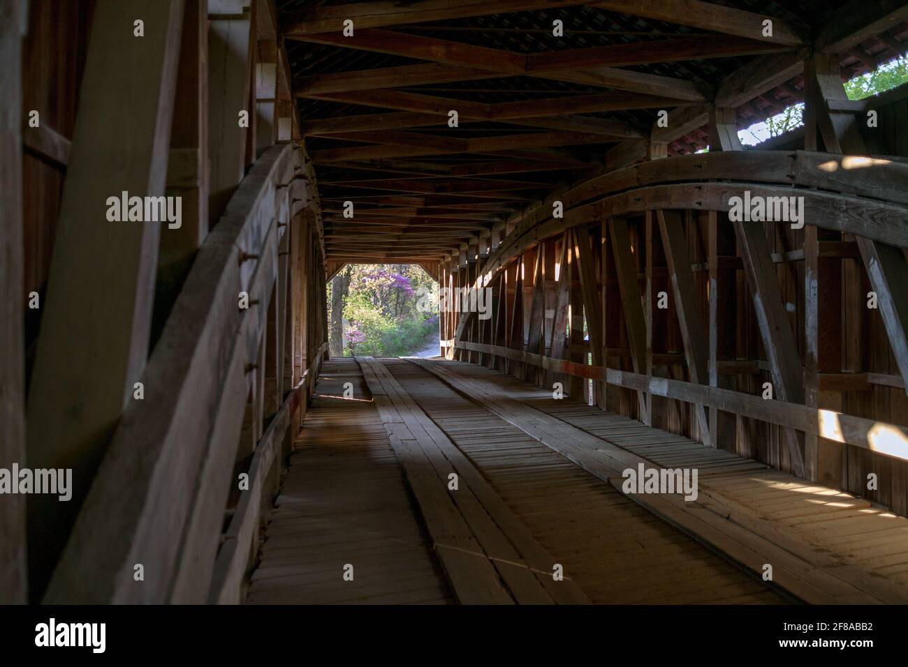 Driving inside a long wooden covered bridge in southern Indiana USA ...