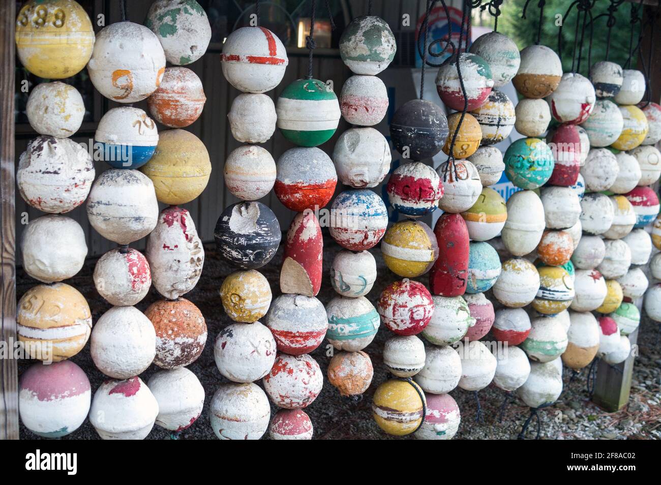 Old foam floats from fishing nets, are strung together to create a ...