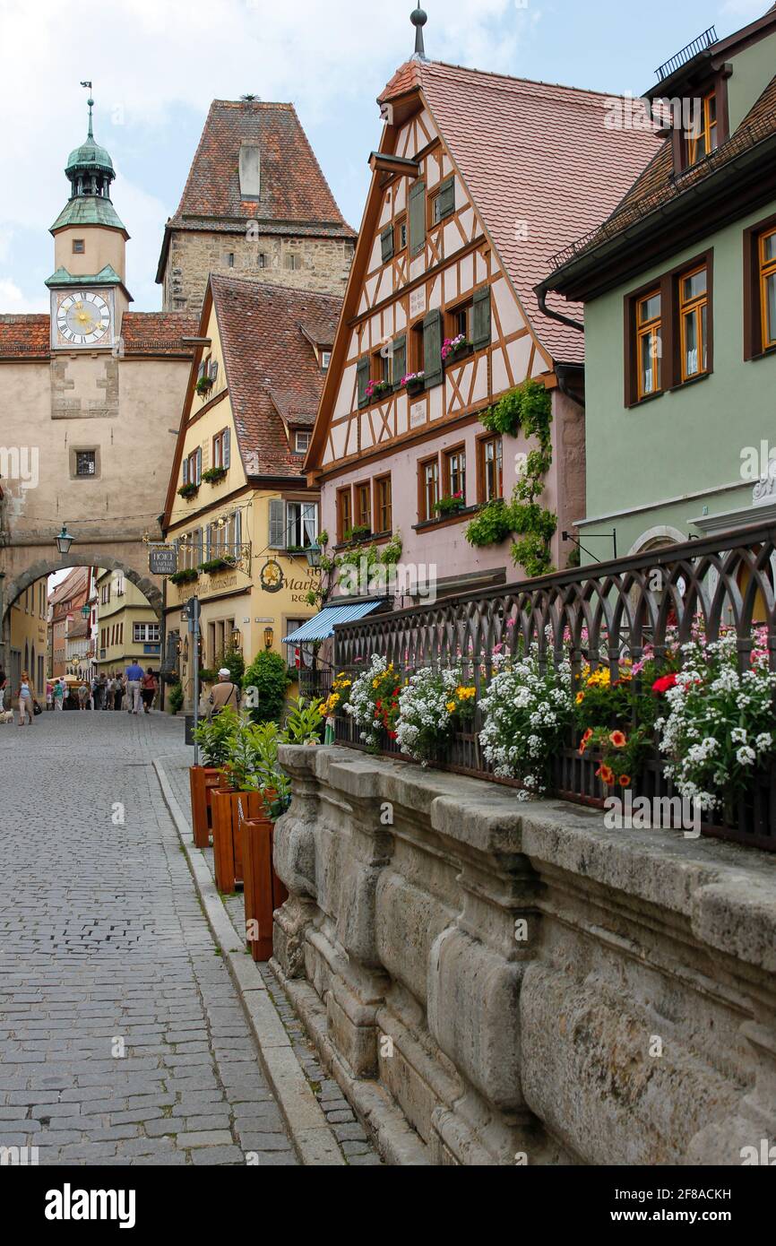 Stone Wall with Flowers and Colorful Buildings and Steeple in ...