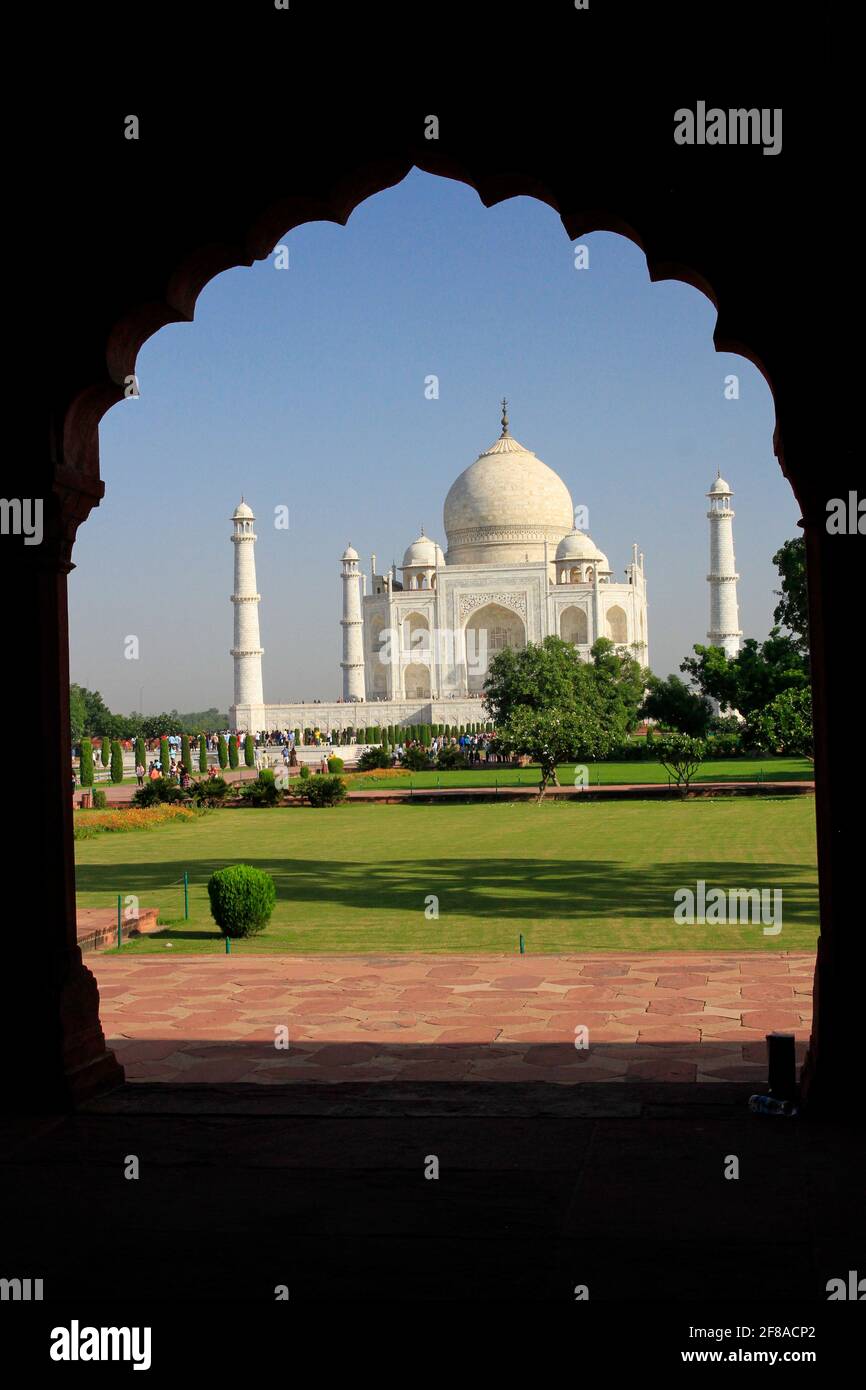 Taj Mahal framed by dark arch with garden in Agra, India Stock Photo ...