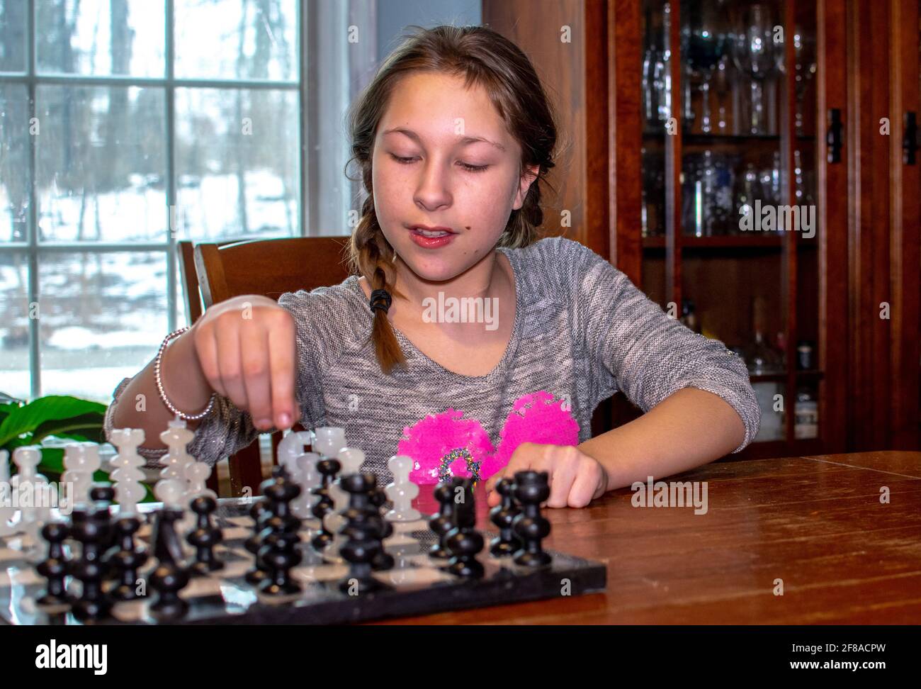 young girl plays chess with a fancy stone chess set Stock Photo - Alamy