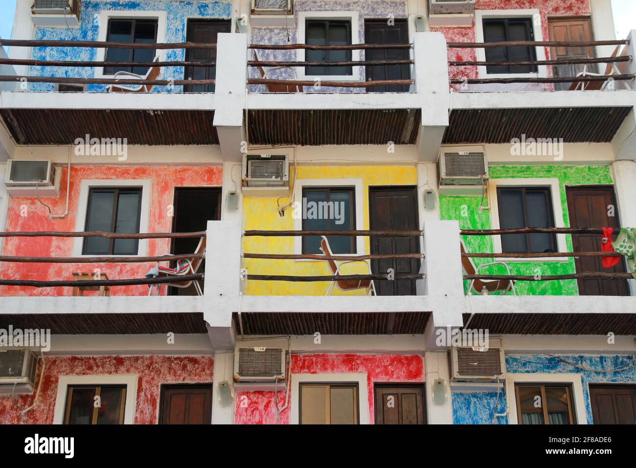 Wall of brightly colored painted apartments of building in Cancun ...