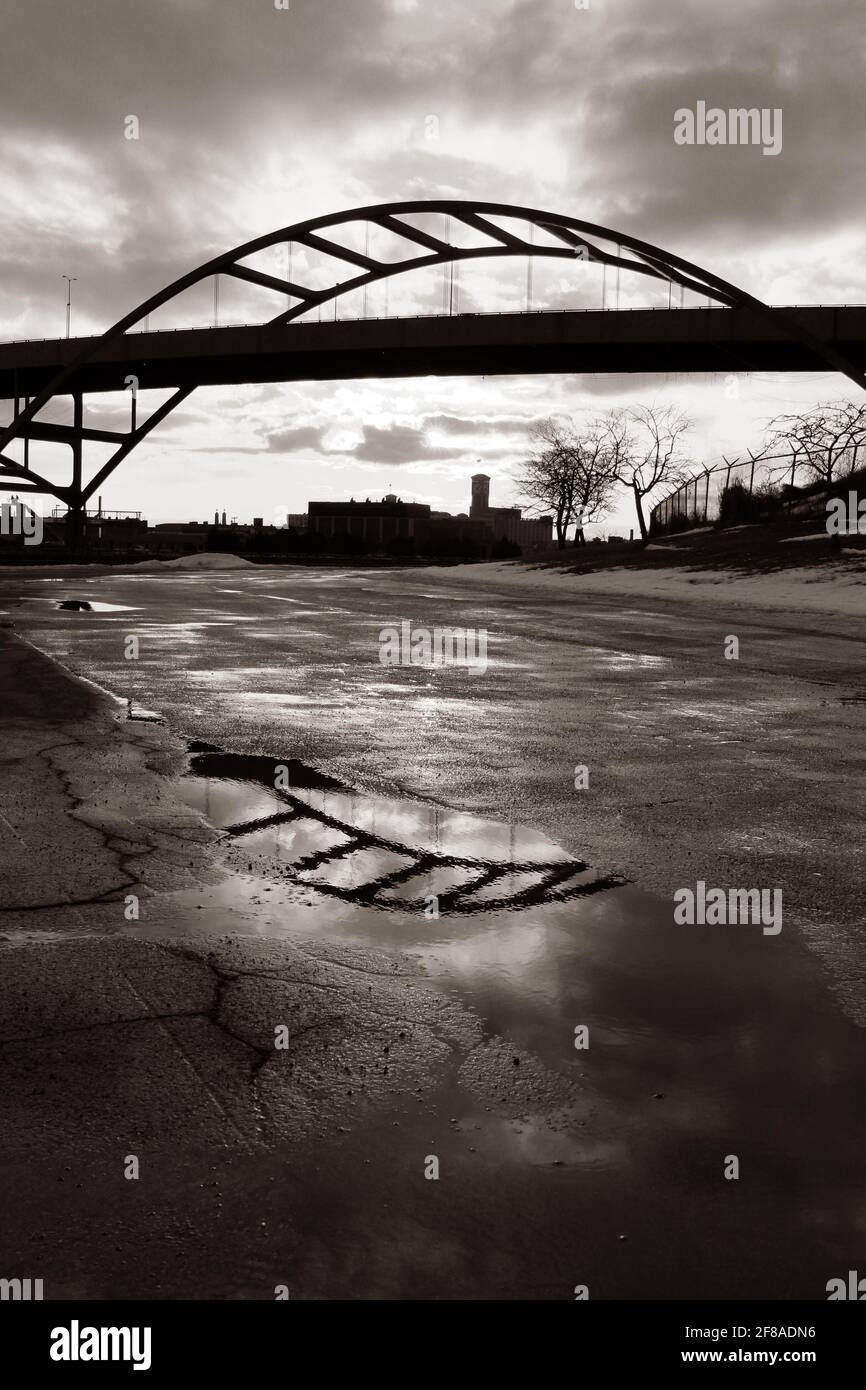 Black and White of Moody Sky and Hone Bridge Reflected in Puddle on ...